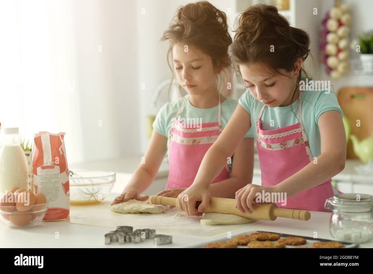 Cute girls baking in the kitchen at home Stock Photo - Alamy