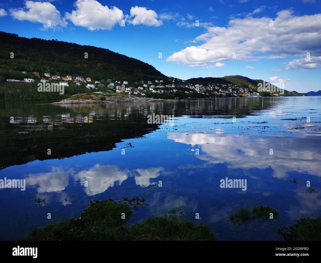 Lake scape with the reflective water surface and hills on the horizon ...