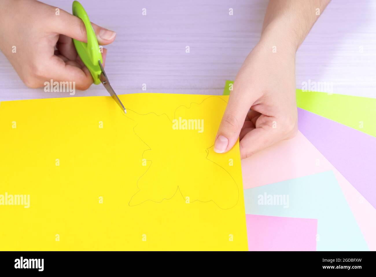 Women hand cutting colorful paper with scissors Stock Photo - Alamy