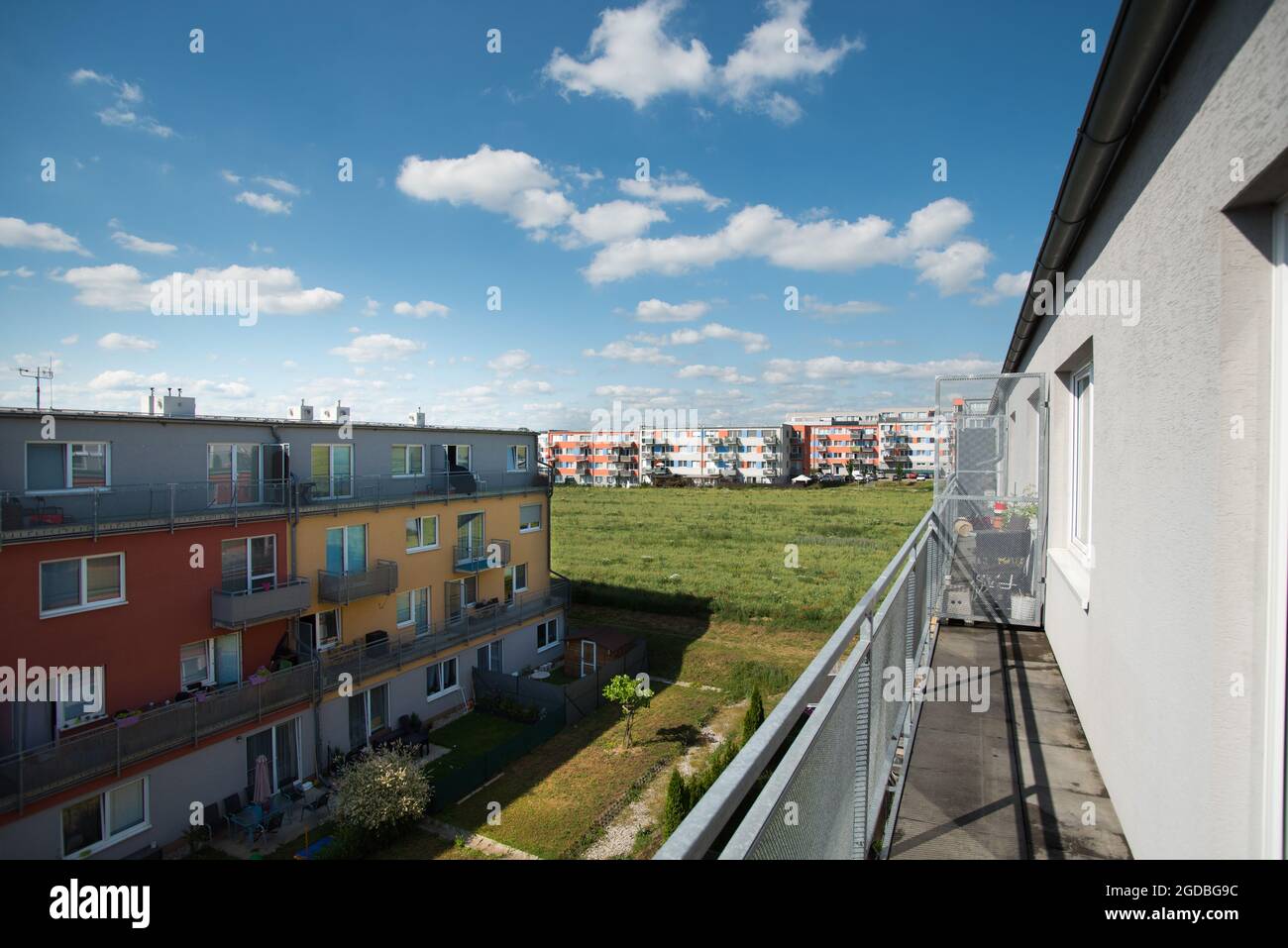 View of a neighborhood of residential buildings from a balcony under a ...