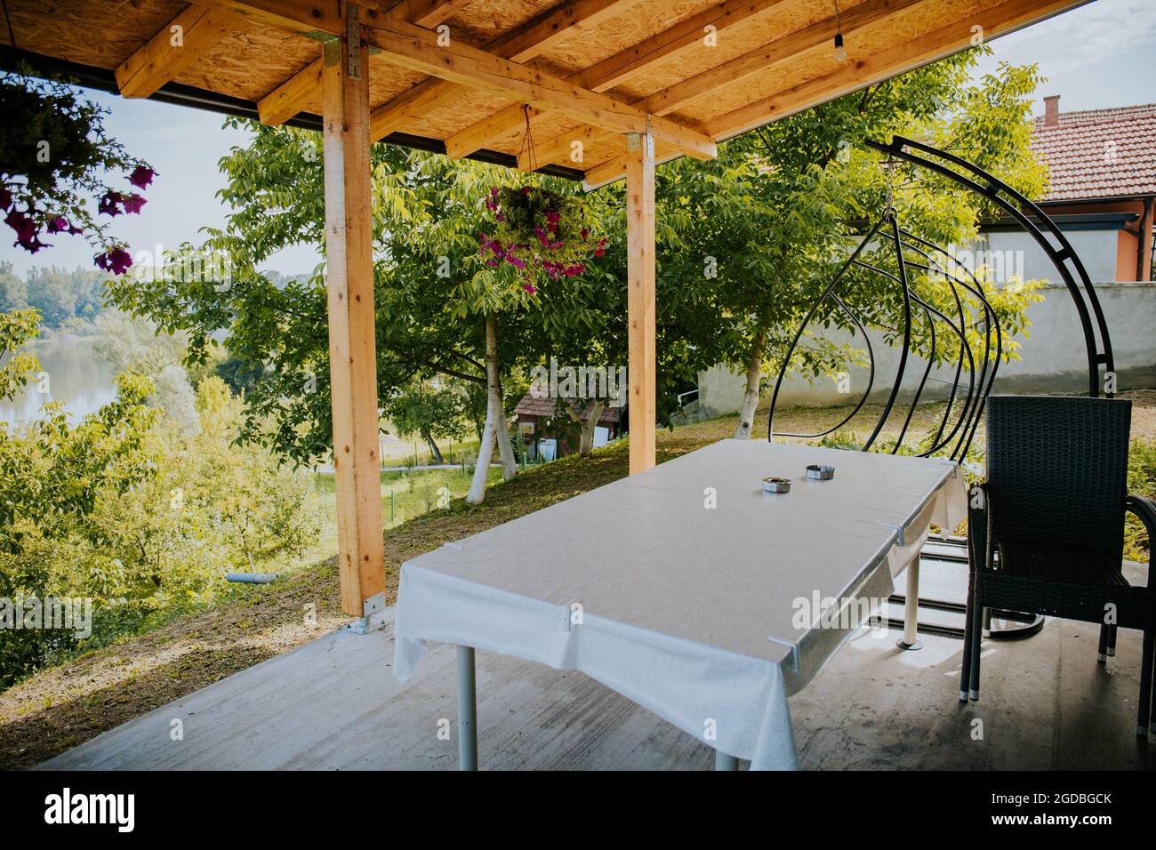 Table in a pavilion surrounded by trees Stock Photo - Alamy