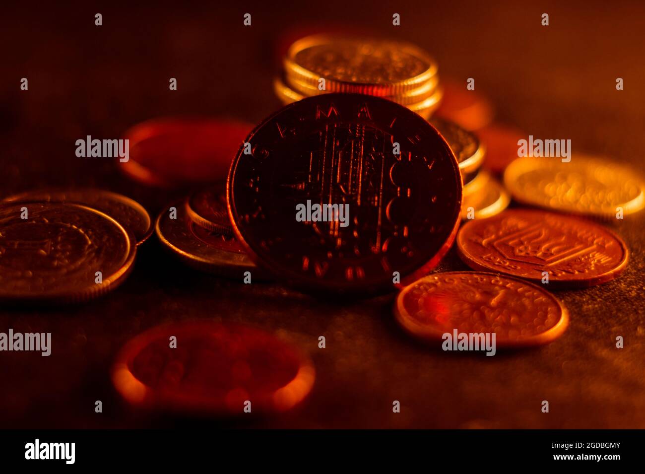 Coins on the table on a blurred background Stock Photo - Alamy