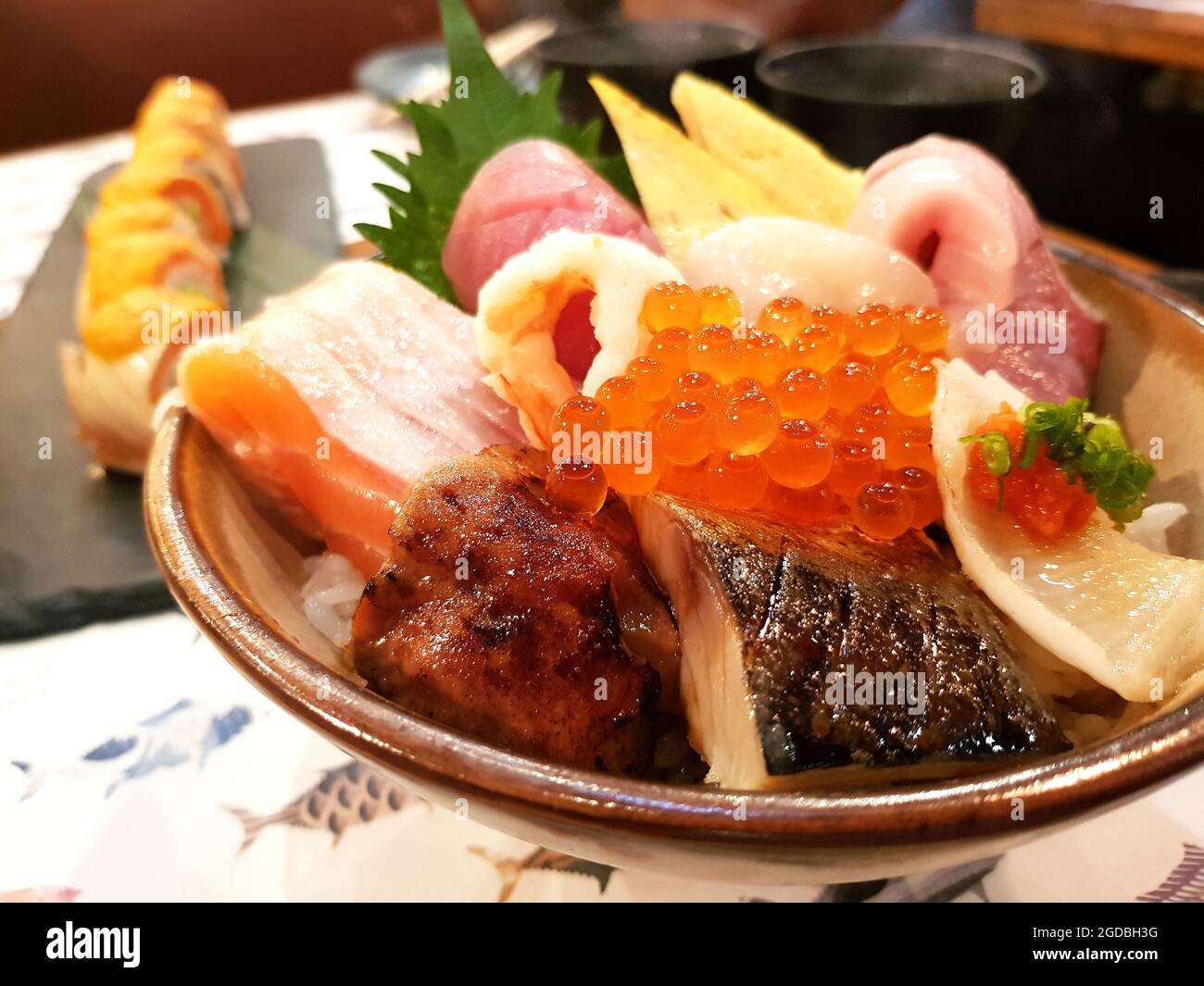Kaisendon sushi don on rice with wood background Stock Photo - Alamy