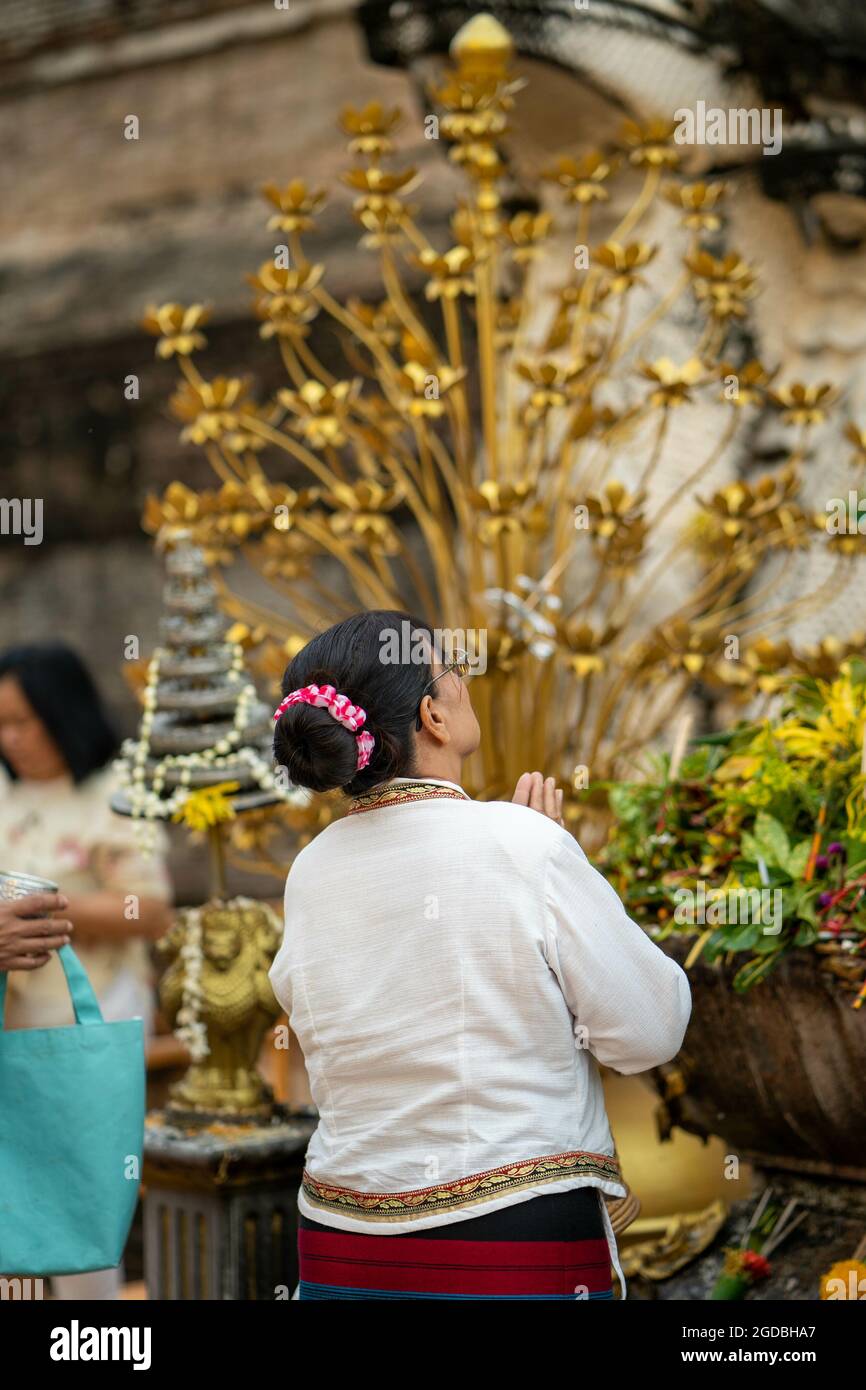 Vertical closeup of a woman praying outdoors Stock Photo - Alamy