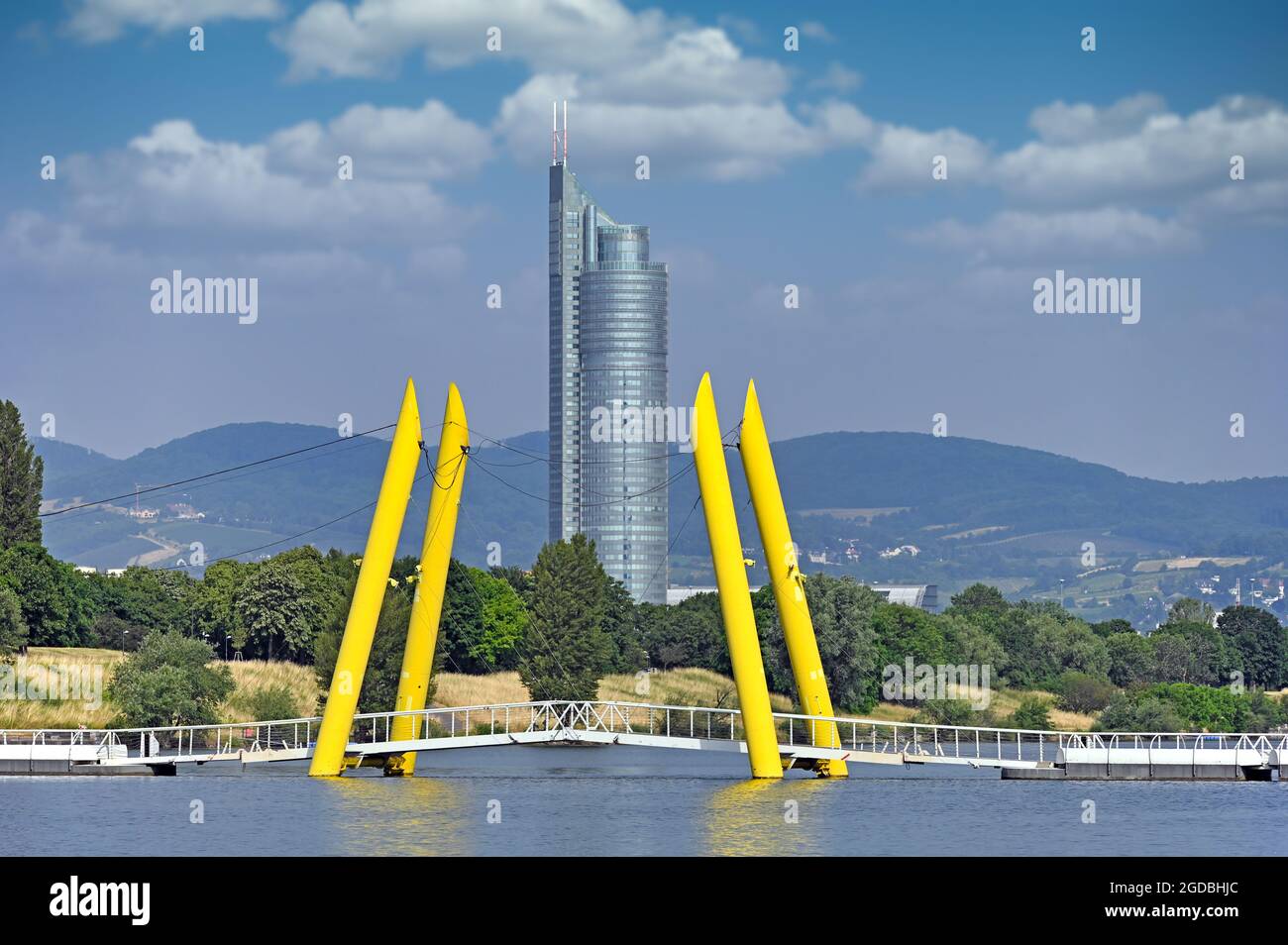 Pedestrian bridge and skyscraper on Danube river in Vienna Stock Photo ...