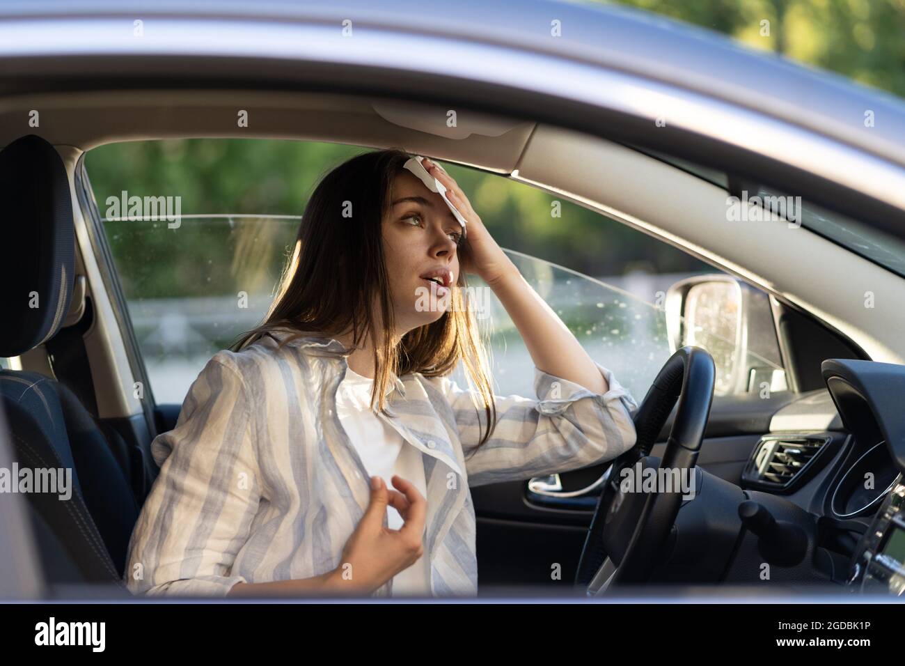 Woman driver being hot during heat wave in car, suffering from hot ...