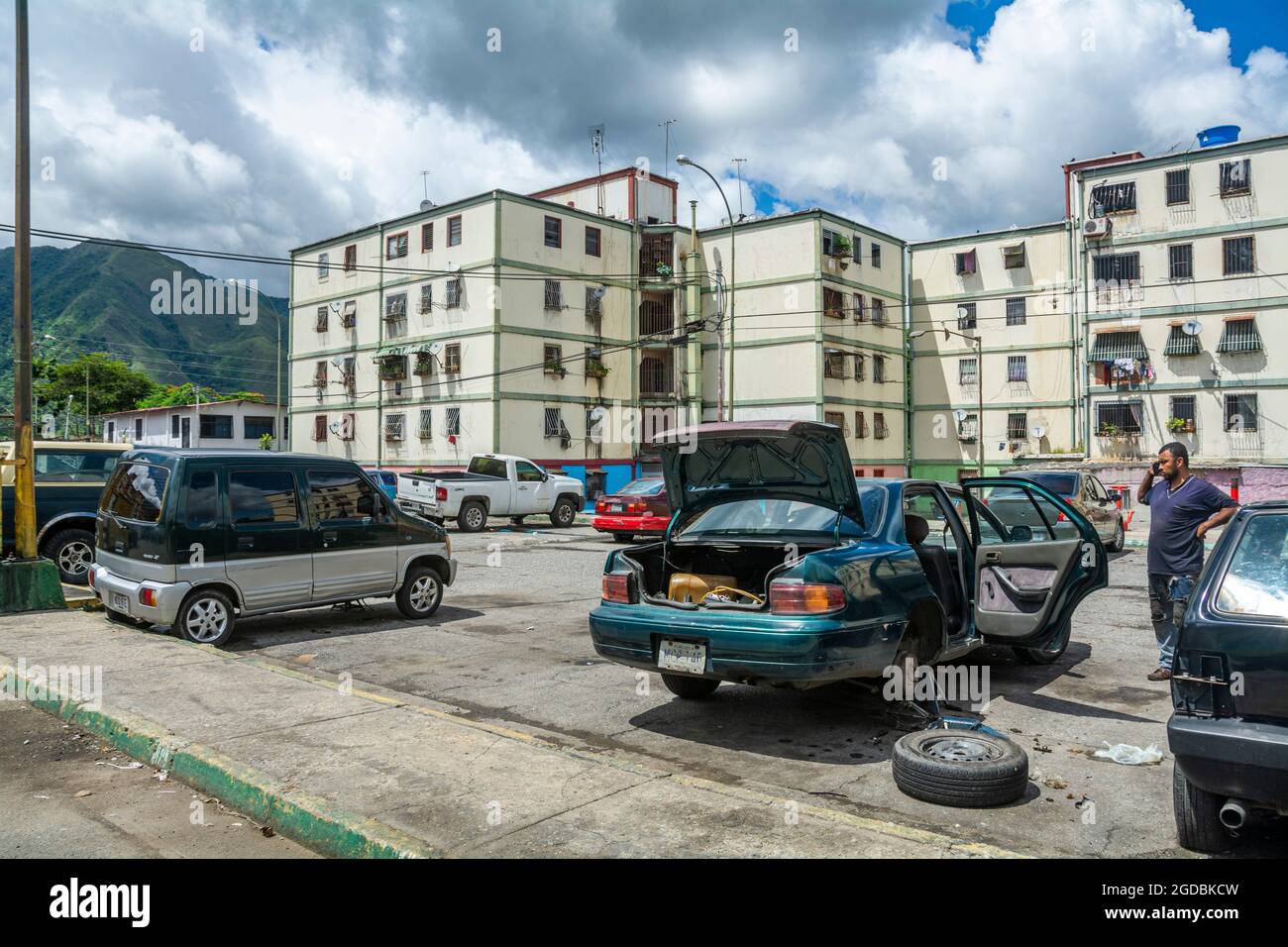 A man talks on his cell phone while repairing a car at the popular ...