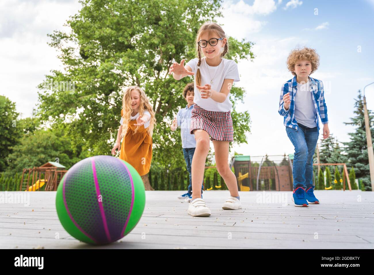 Multiracial group of kids playing at playground during break - Playful ...