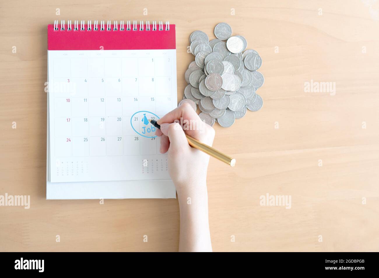 Hand writing in calendar plan and coins concept, Job Stock Photo - Alamy