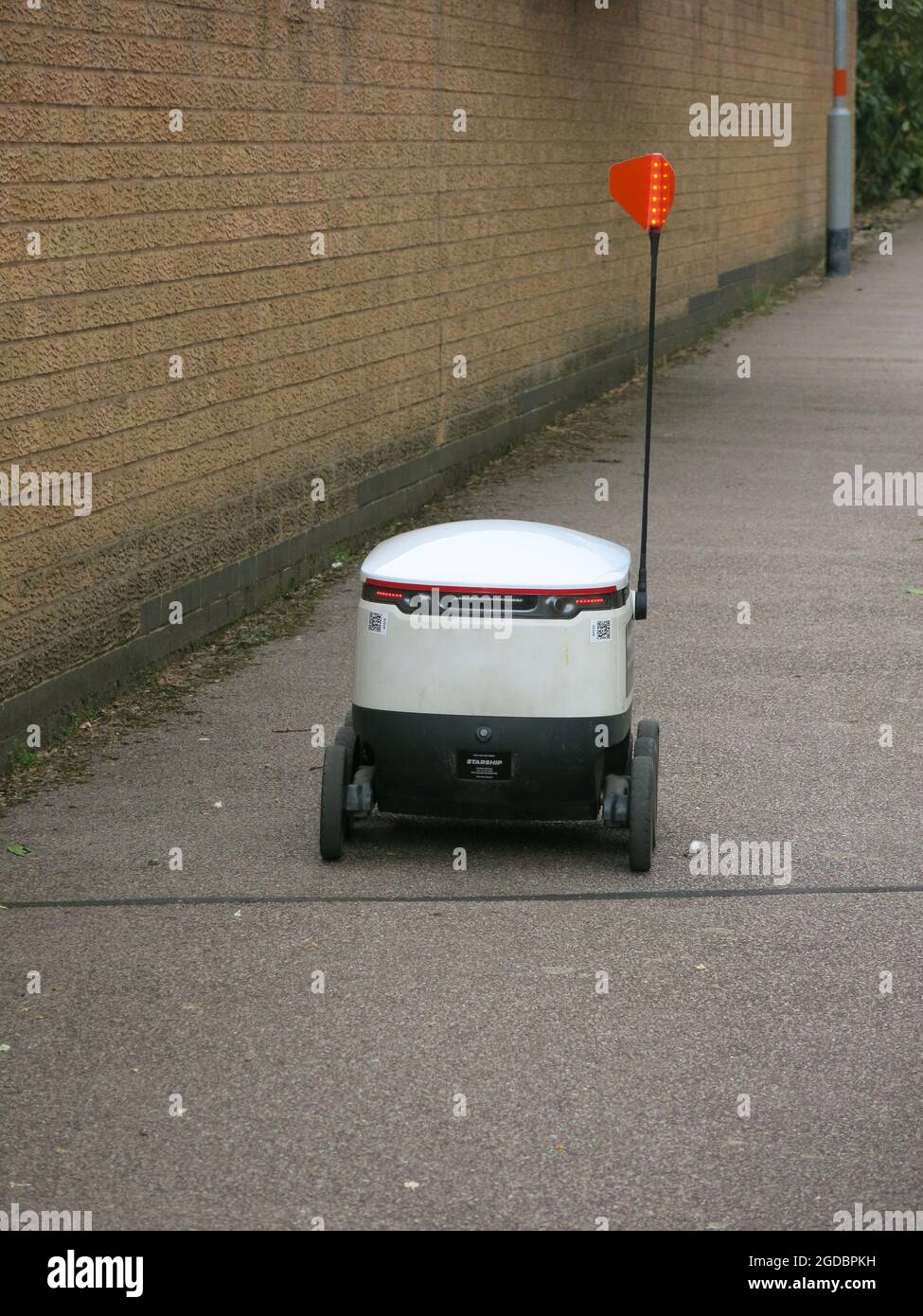 Robot travelling along a pavement in a residential area, being used to ...