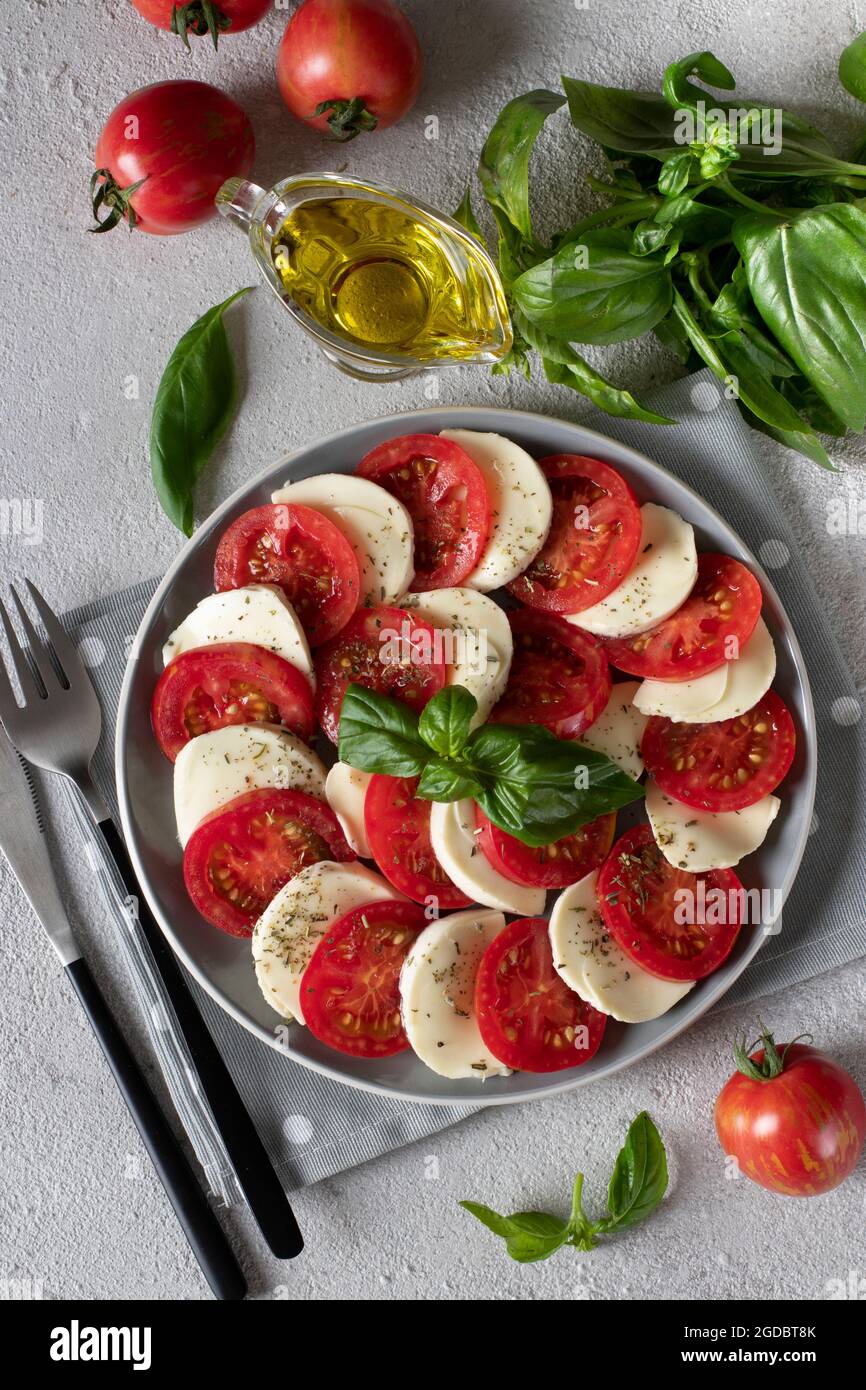 Italian caprese salad with sliced tomatoes, mozzarella cheese, basil ...