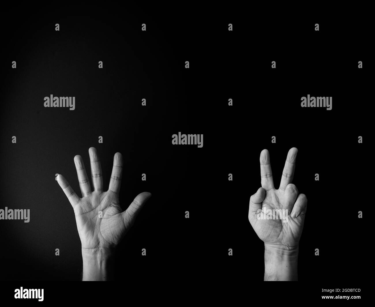 Dramatic black and white image of male hand demonstrating sign language ...