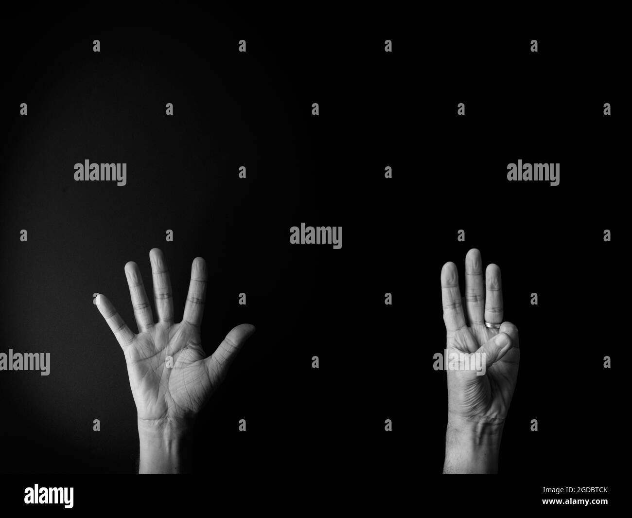 Dramatic black and white image of male hand demonstrating sign language ...