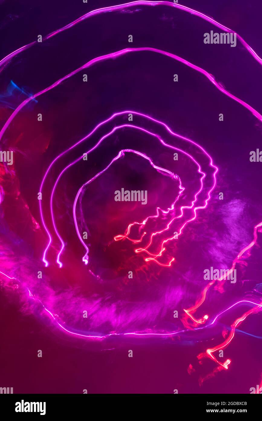 Pink circular electricity like light streaks on pink background Stock ...