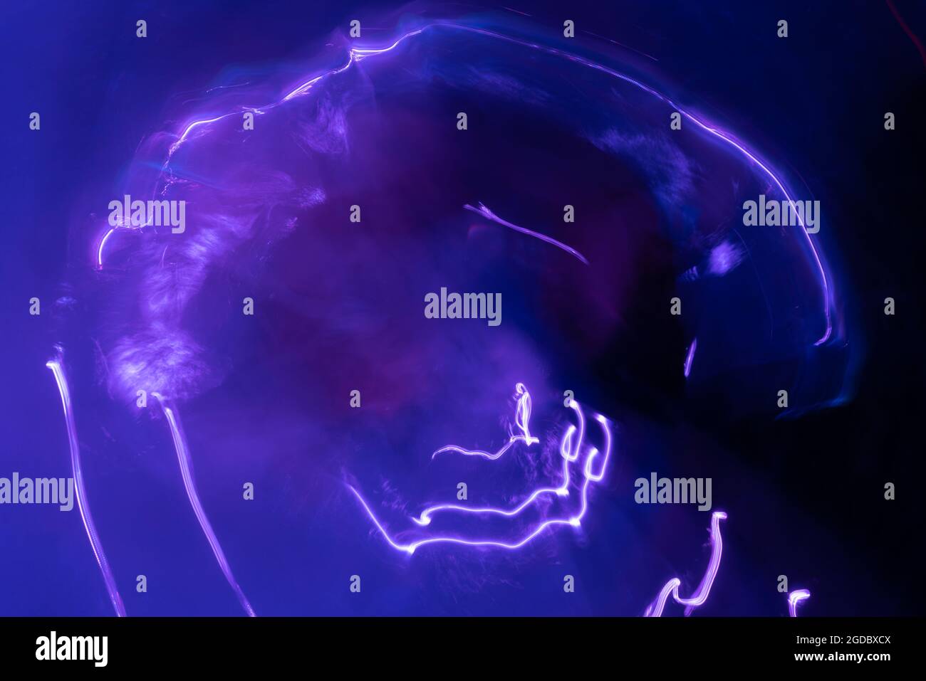 Blue squiggly and circular electricity like light streaks on blue ...