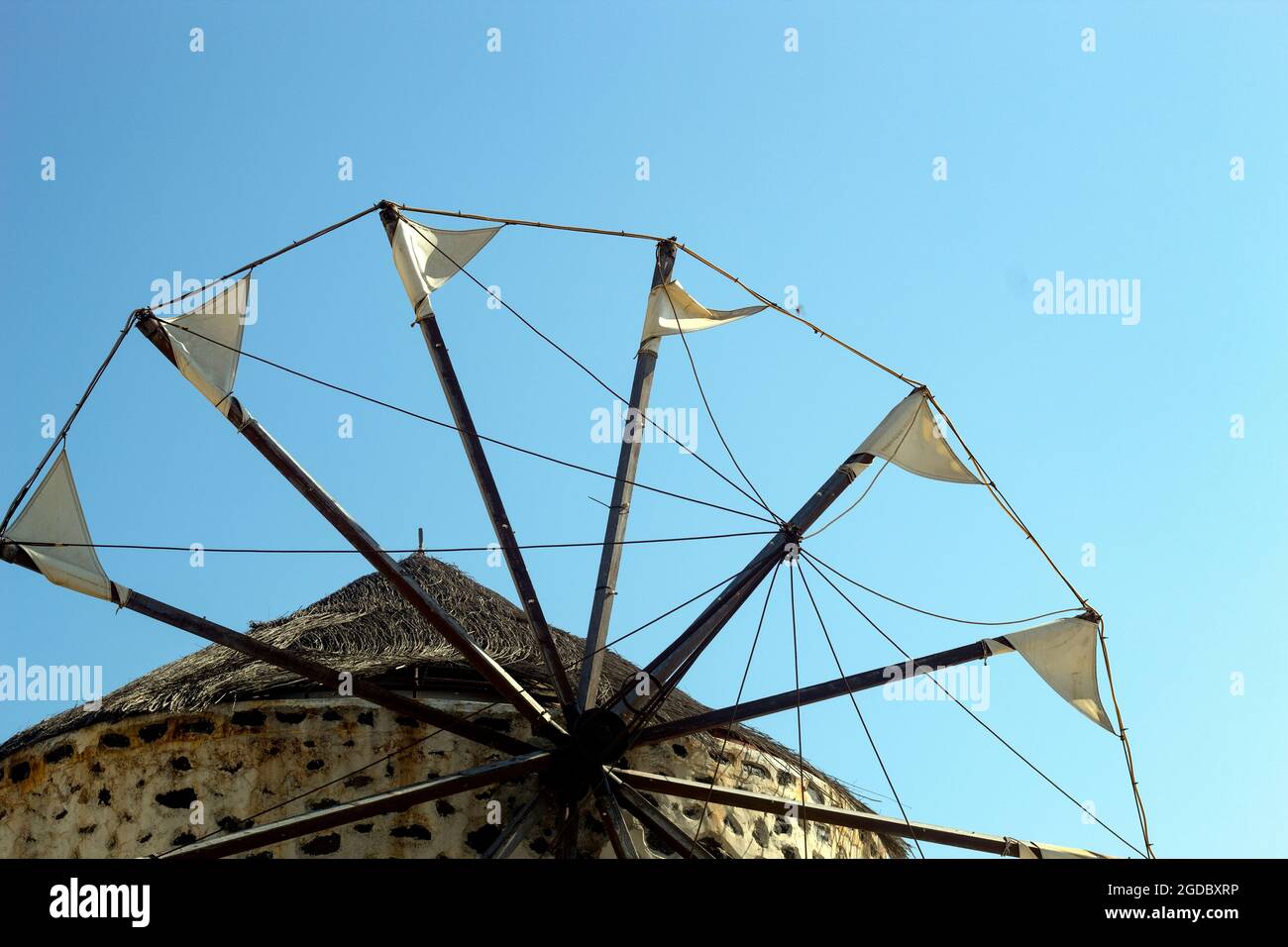 Greece, the isle of Santorini. A lone windmill. The white sails ...