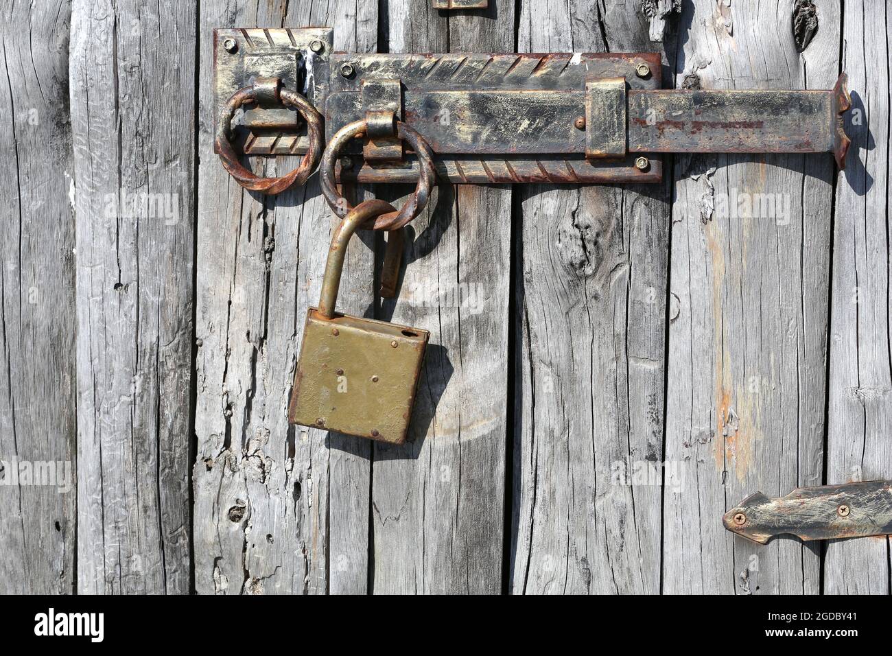 Wooden door with big lock Stock Photo - Alamy