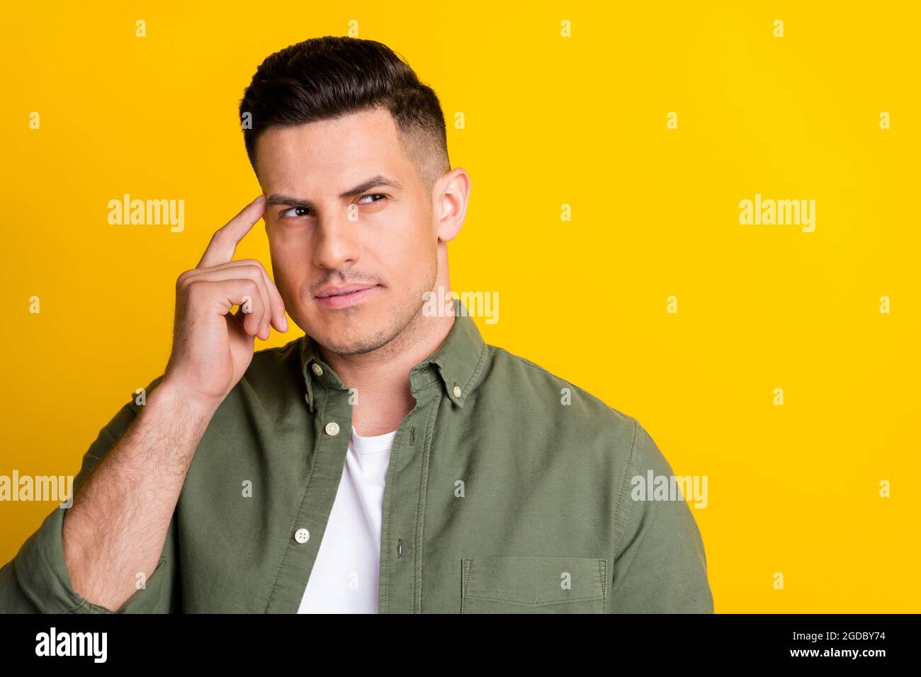 Photo of young man finger touch head think ponder look empty space ...