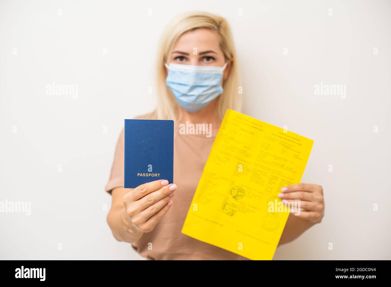 Woman with medical mask holding inernational certificate of the ...