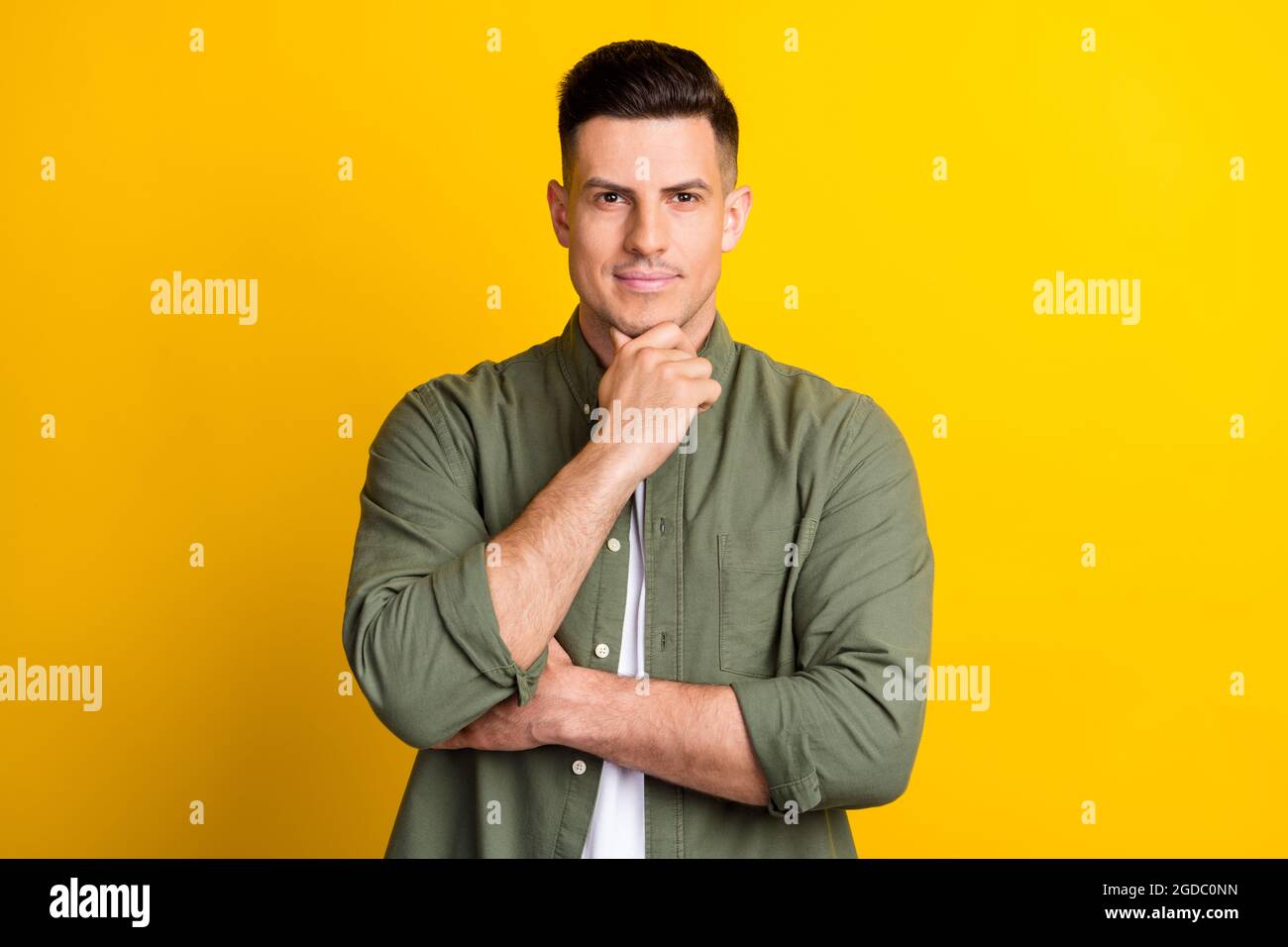 Portrait of attractive content cool guy touching chin making decision ...