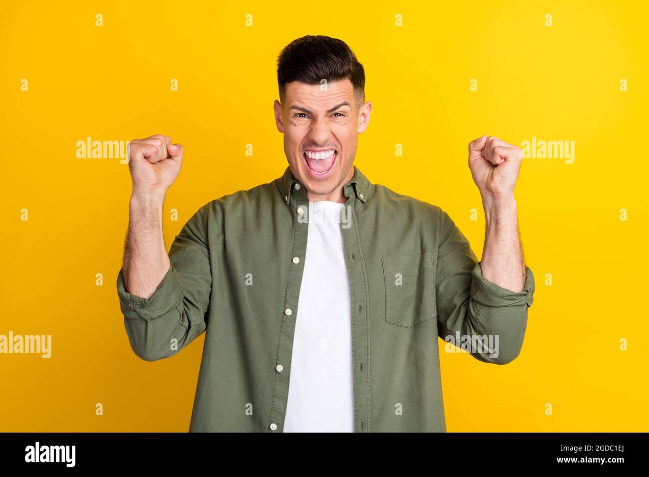 Portrait of attractive cheerful lucky crazy guy celebrating having fun ...