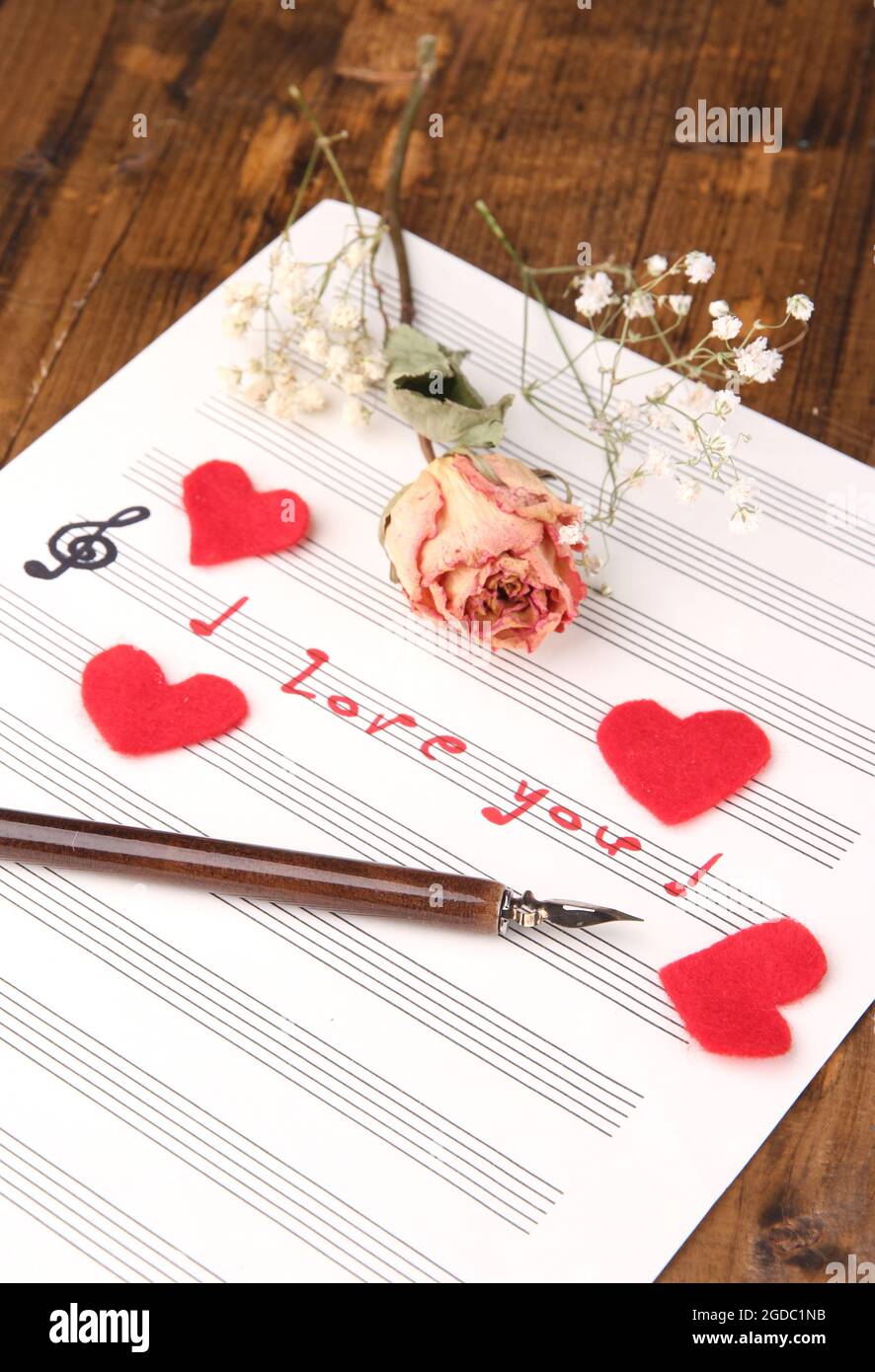 Music notes in music note book. Concept of love melody Stock Photo - Alamy