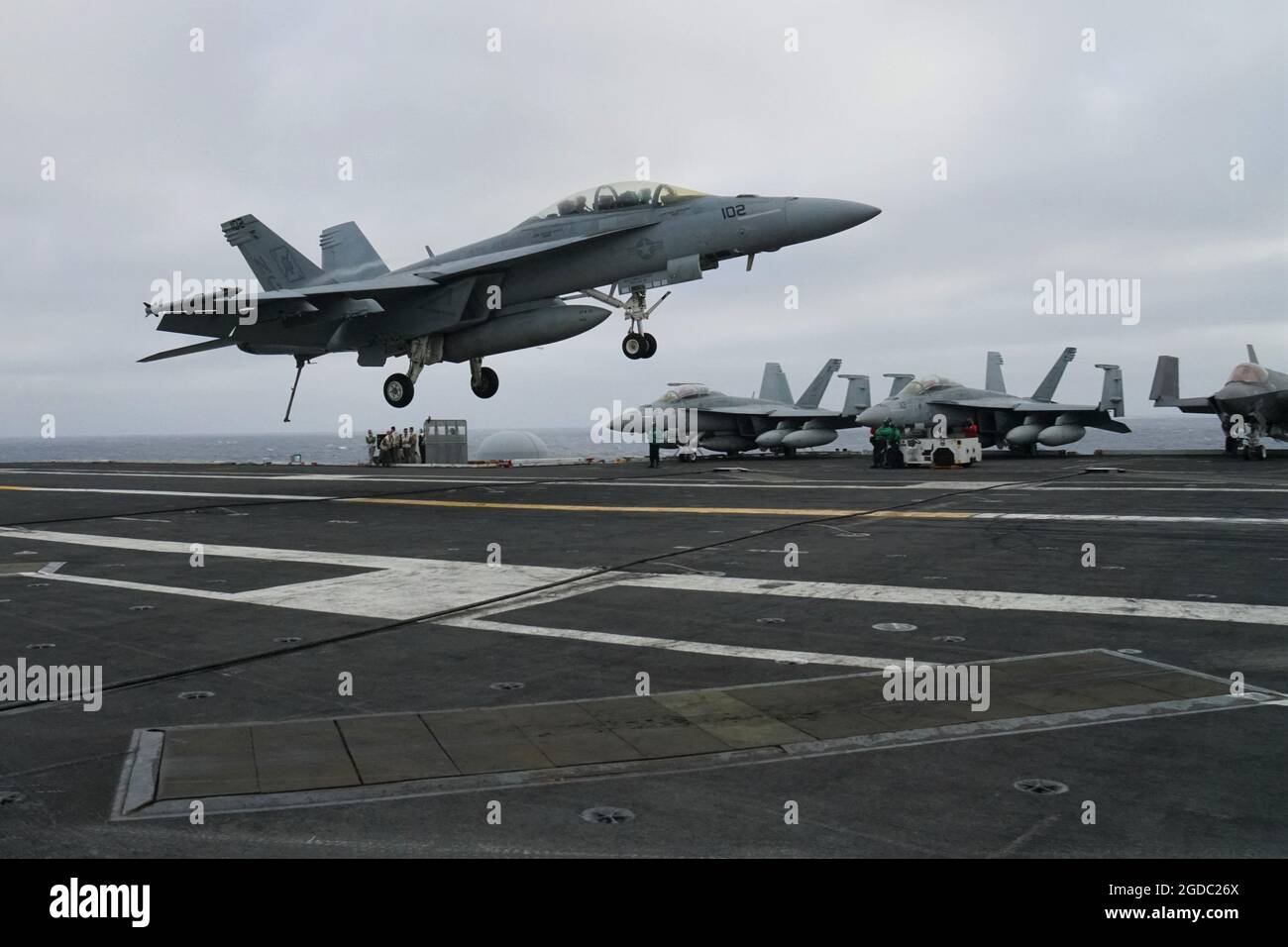 Various aircraft on final approach to a aircraft carrier at sea Stock ...