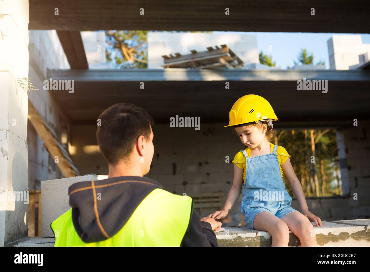 Dad and daughter are at construction site of their future home. The ...
