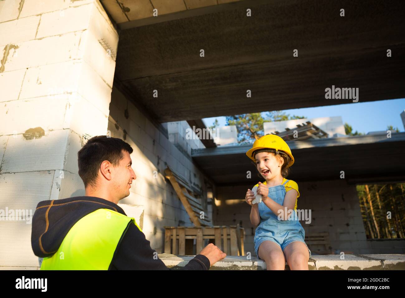 Dad and daughter are at construction site of their future home. The ...