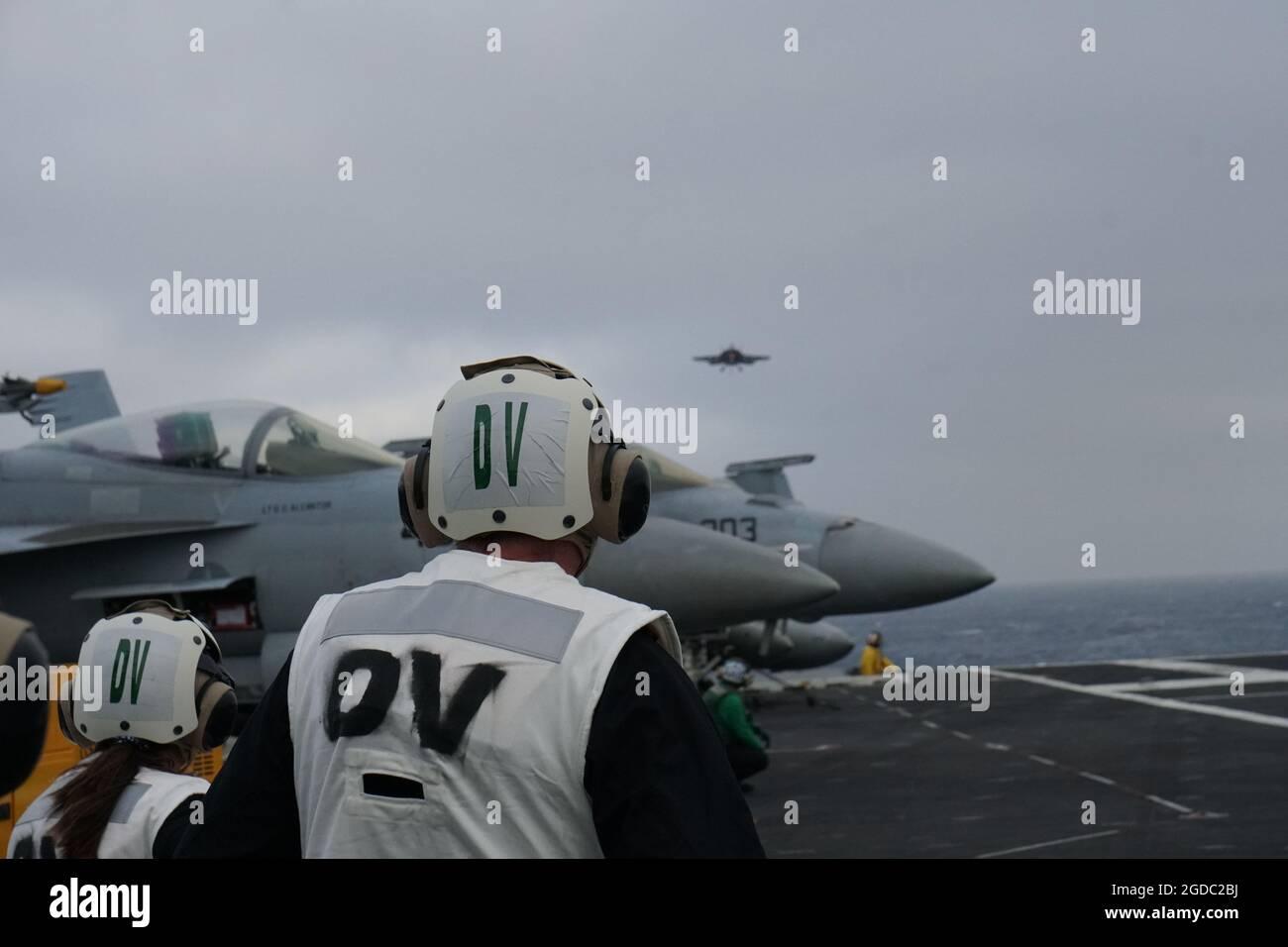 Various aircraft on final approach to a aircraft carrier at sea Stock ...