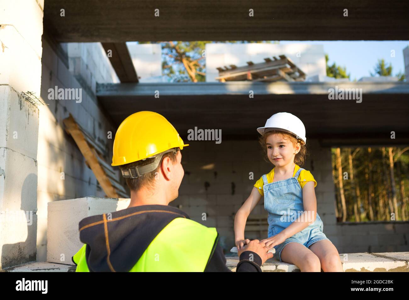 Dad and daughter are at construction site of their future home. The ...