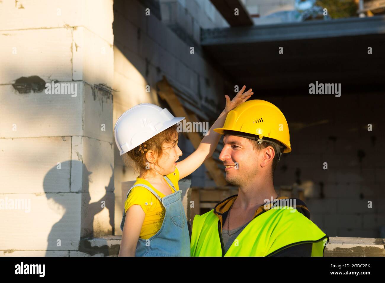 Dad and daughter are at construction site of their future home. The ...