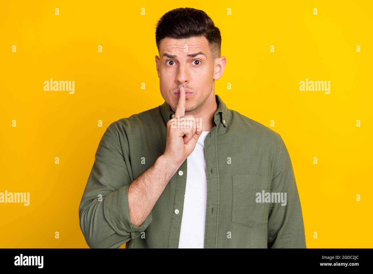 Photo portrait man keeping finger near lips secret isolated vibrant ...