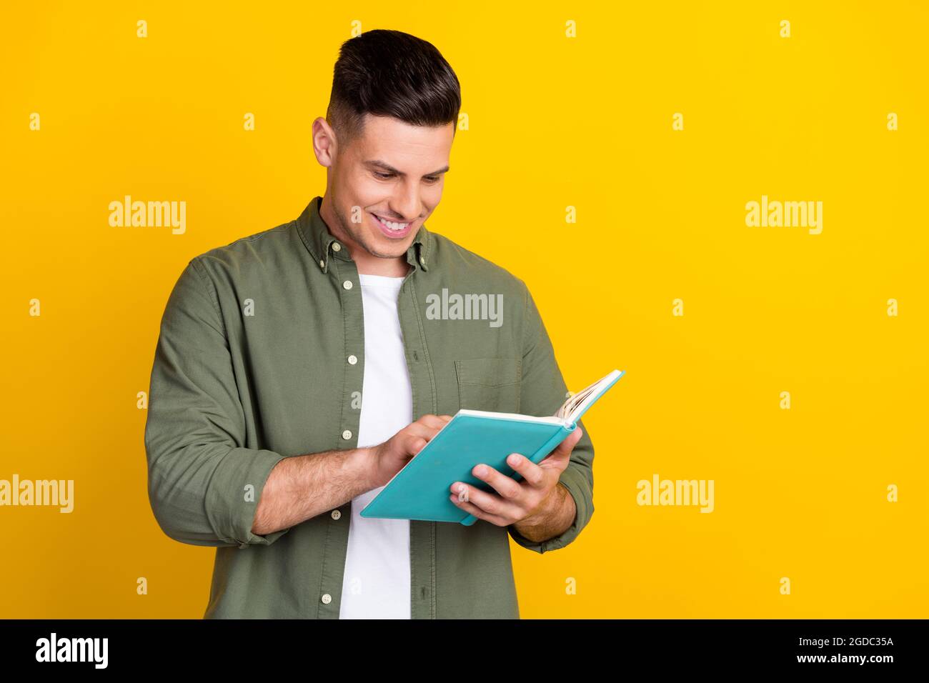 Portrait of attractive cheerful smart clever focused guy reading ...