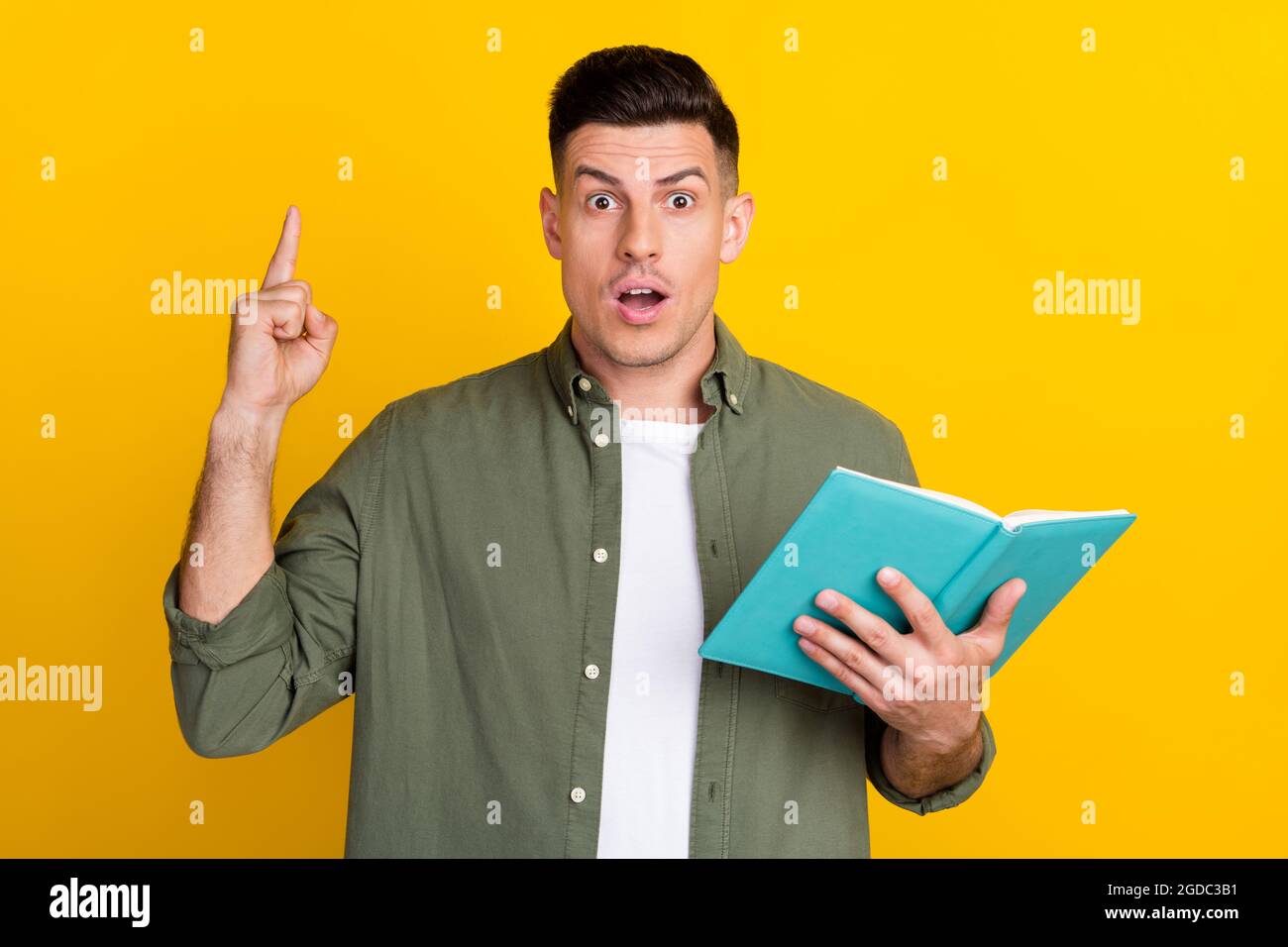 Photo of young guy point finger idea solution read book information ...