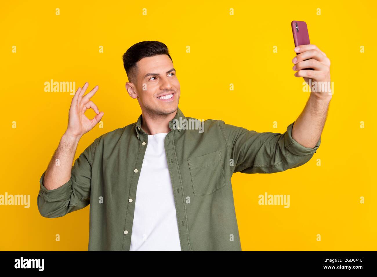 Photo portrait man smiling showing okay taking selfie isolated bright ...