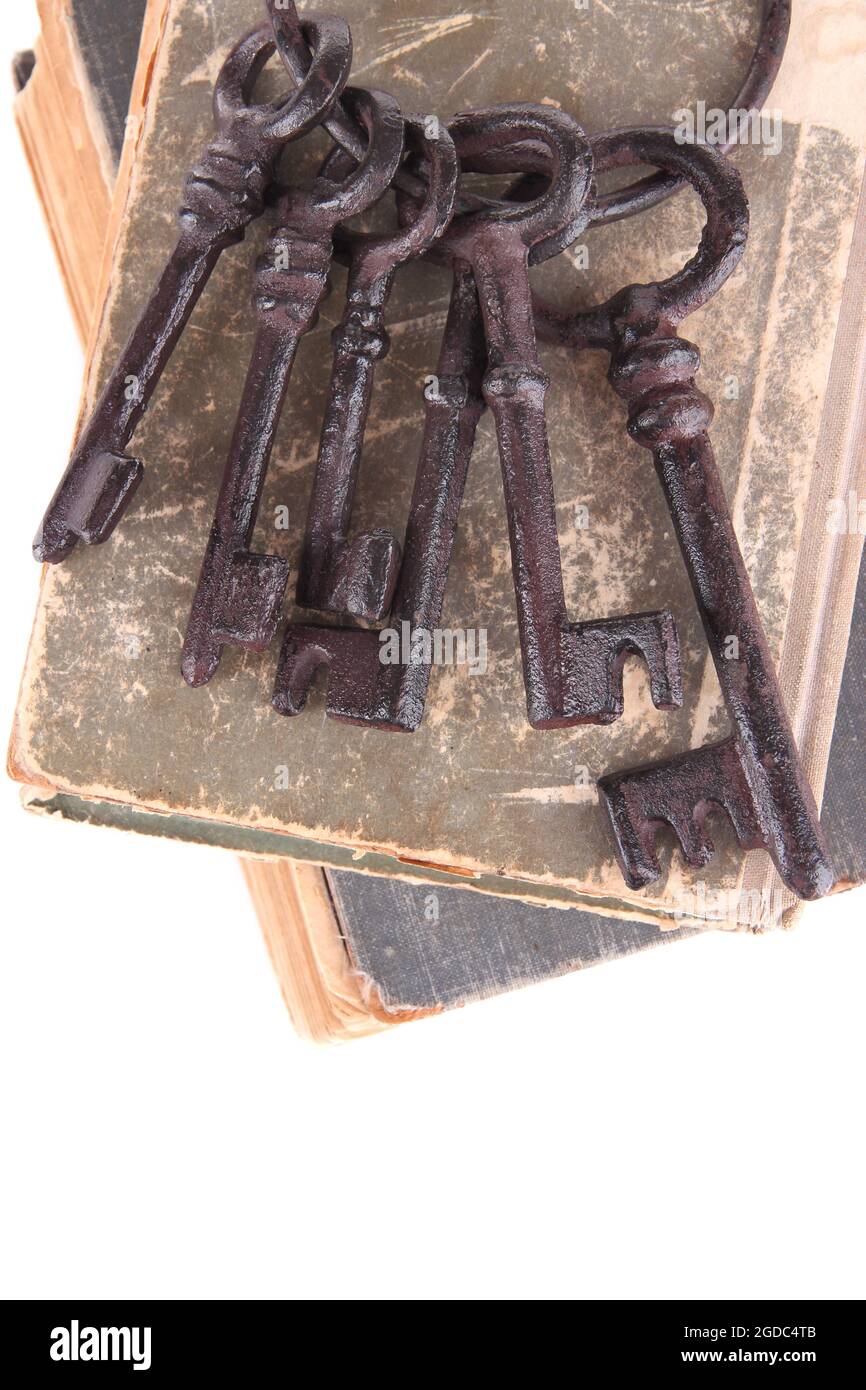 Old keys on old books isolated on white Stock Photo - Alamy