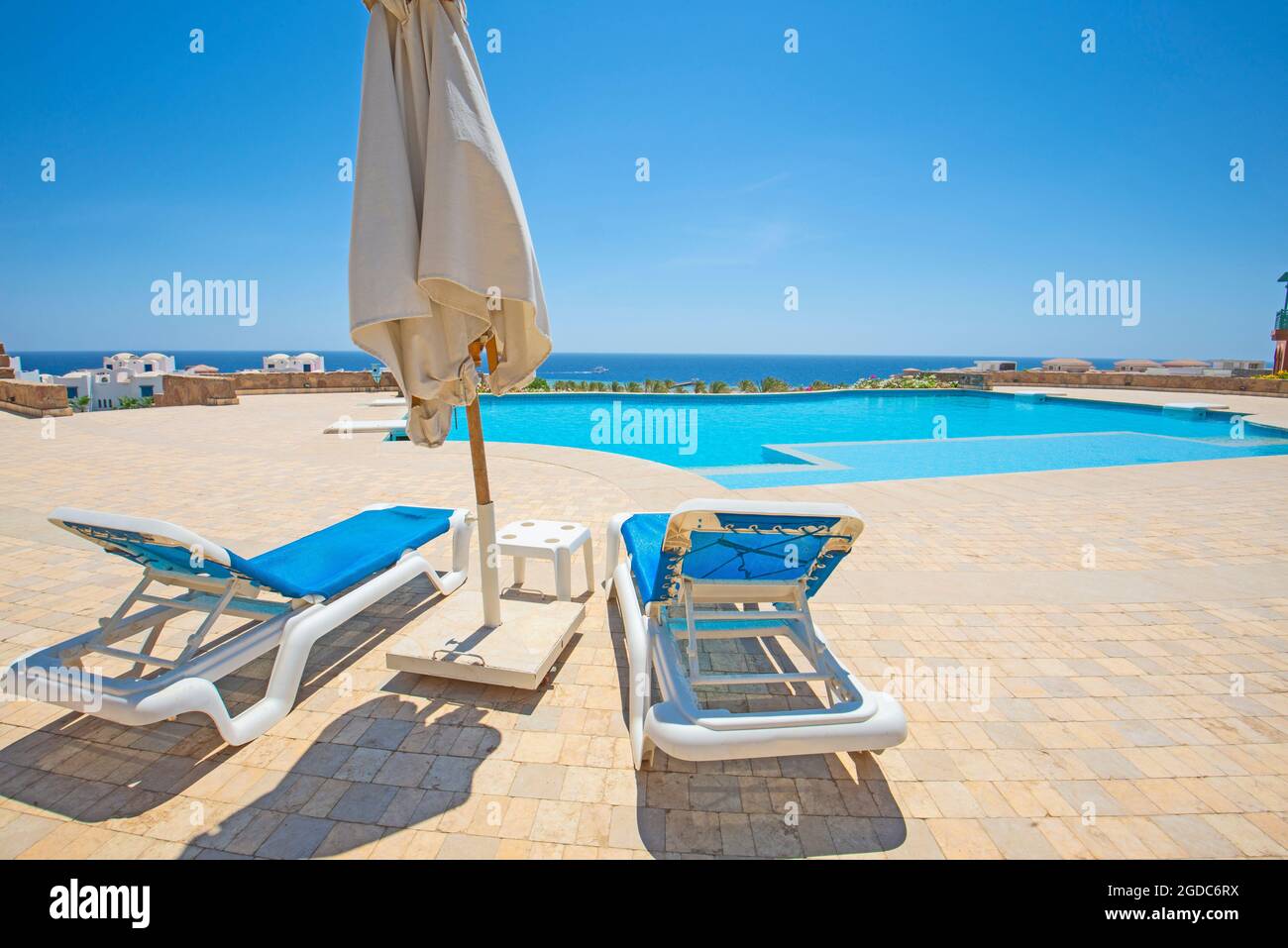Large outdoor swimming pool at a luxury tropical hotel resort with sun ...
