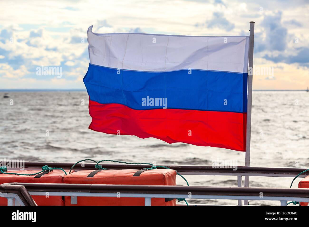 Russian flag waving on the deck of a ship against the background of the ...