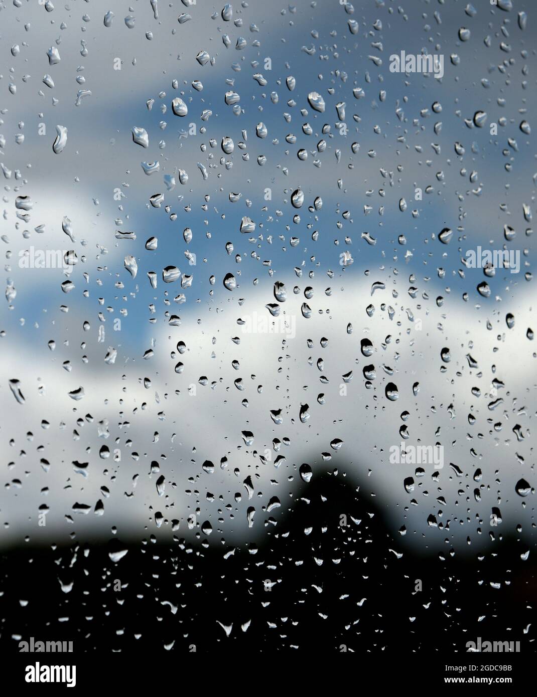 Raindrops adhere to a window as a monsoon storm passes over Santa Fe ...