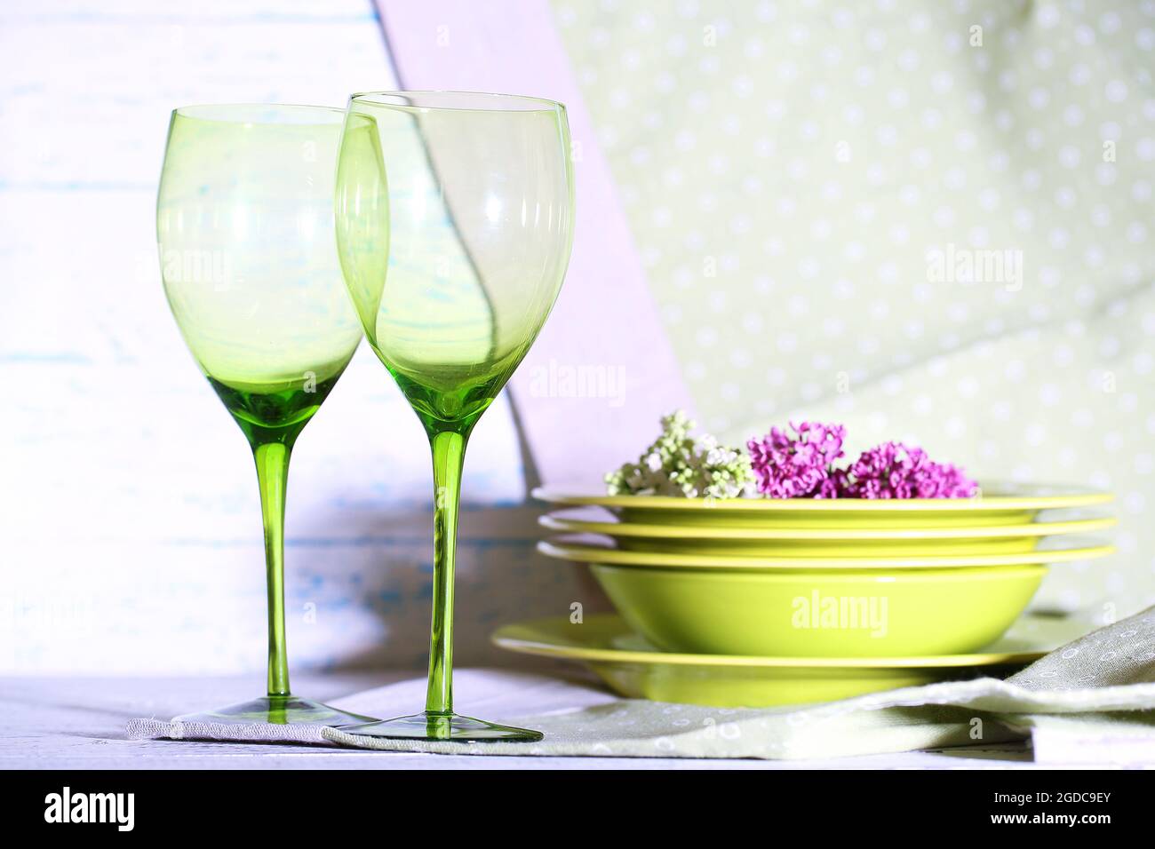 Green table settings, on table, on light background Stock Photo - Alamy