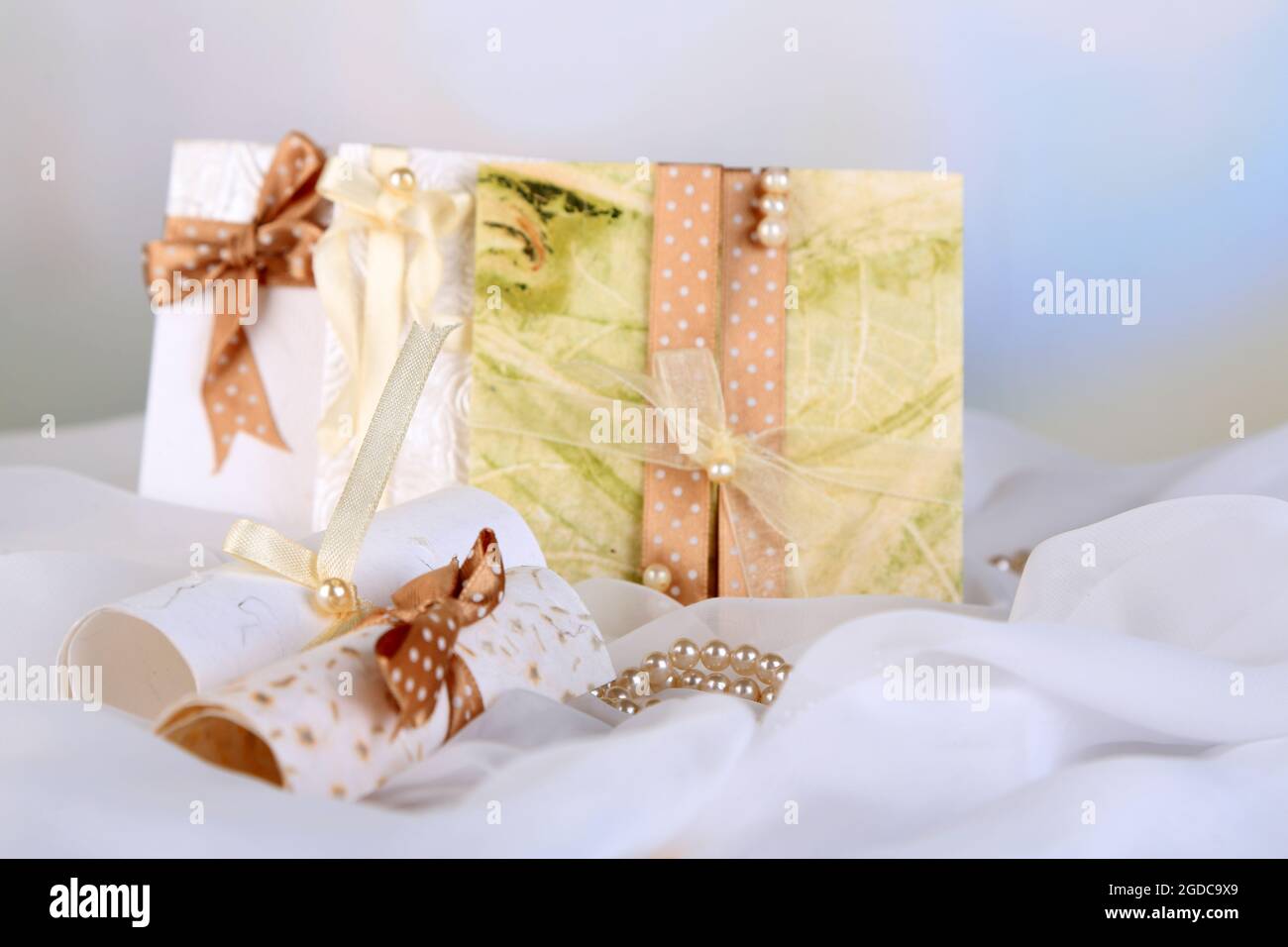 Beautiful handmade wedding cards on light background Stock Photo - Alamy