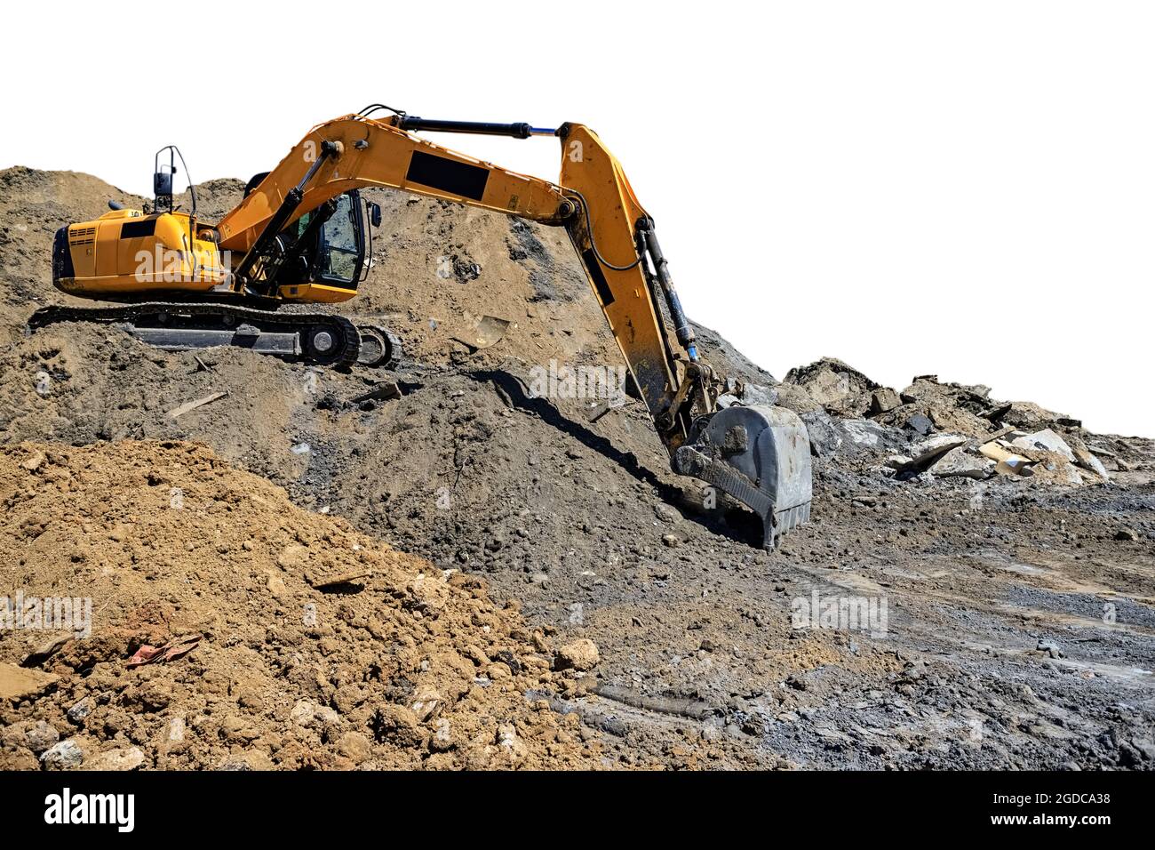 Yellow earth-moving machine on a large pile of sand isolated on white ...