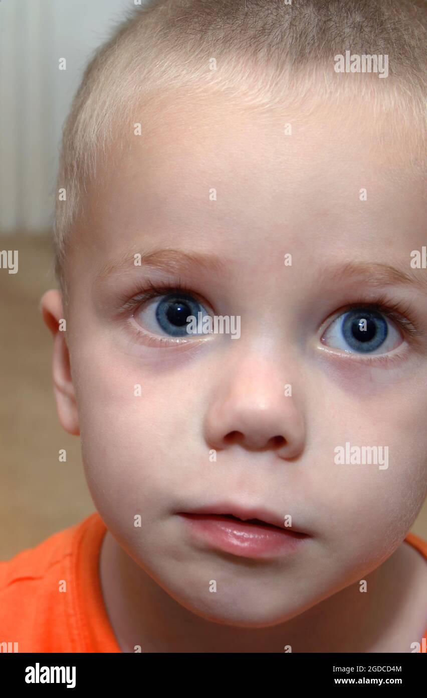 Wide open blue eyes shows innocence and a boy like wonder. Closeup of ...