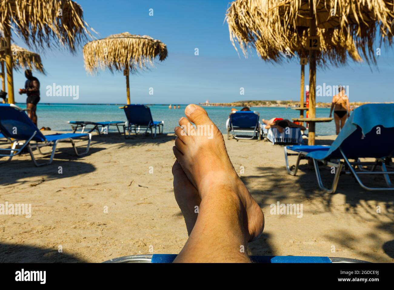 view of the legs on the sunny beach Stock Photo - Alamy