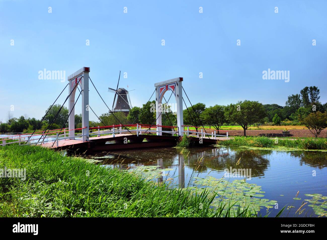 DeZwaan Windmill is framed by the Dutch style pedestrian bridge on ...