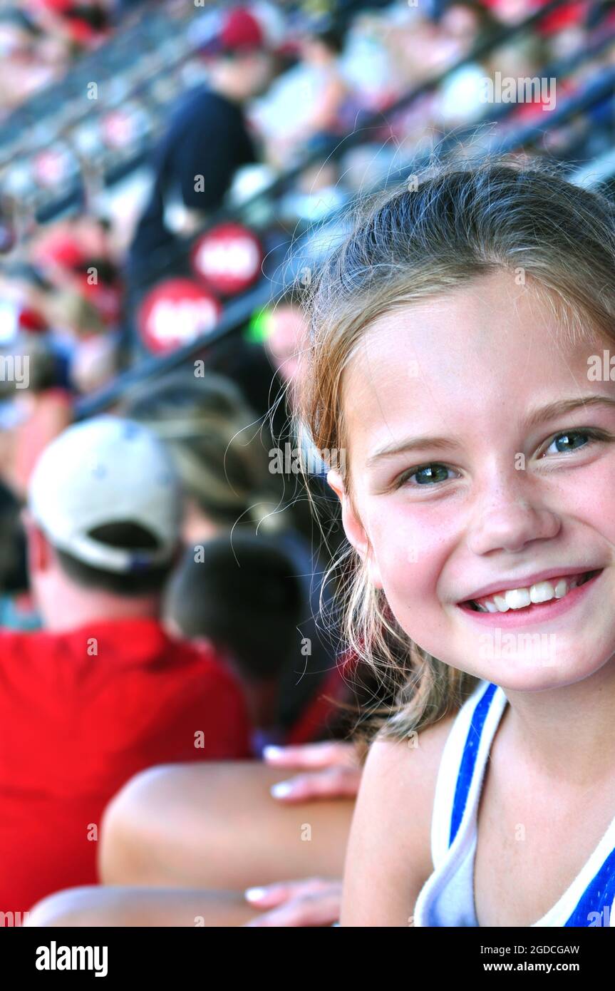 Little girl smiles her excitement as she sits at her first professional ...