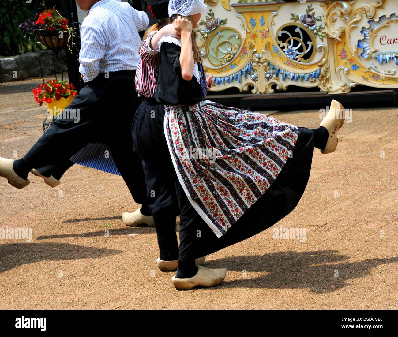 Young couples, in costume, dance a traditional Dutch dance. They are ...