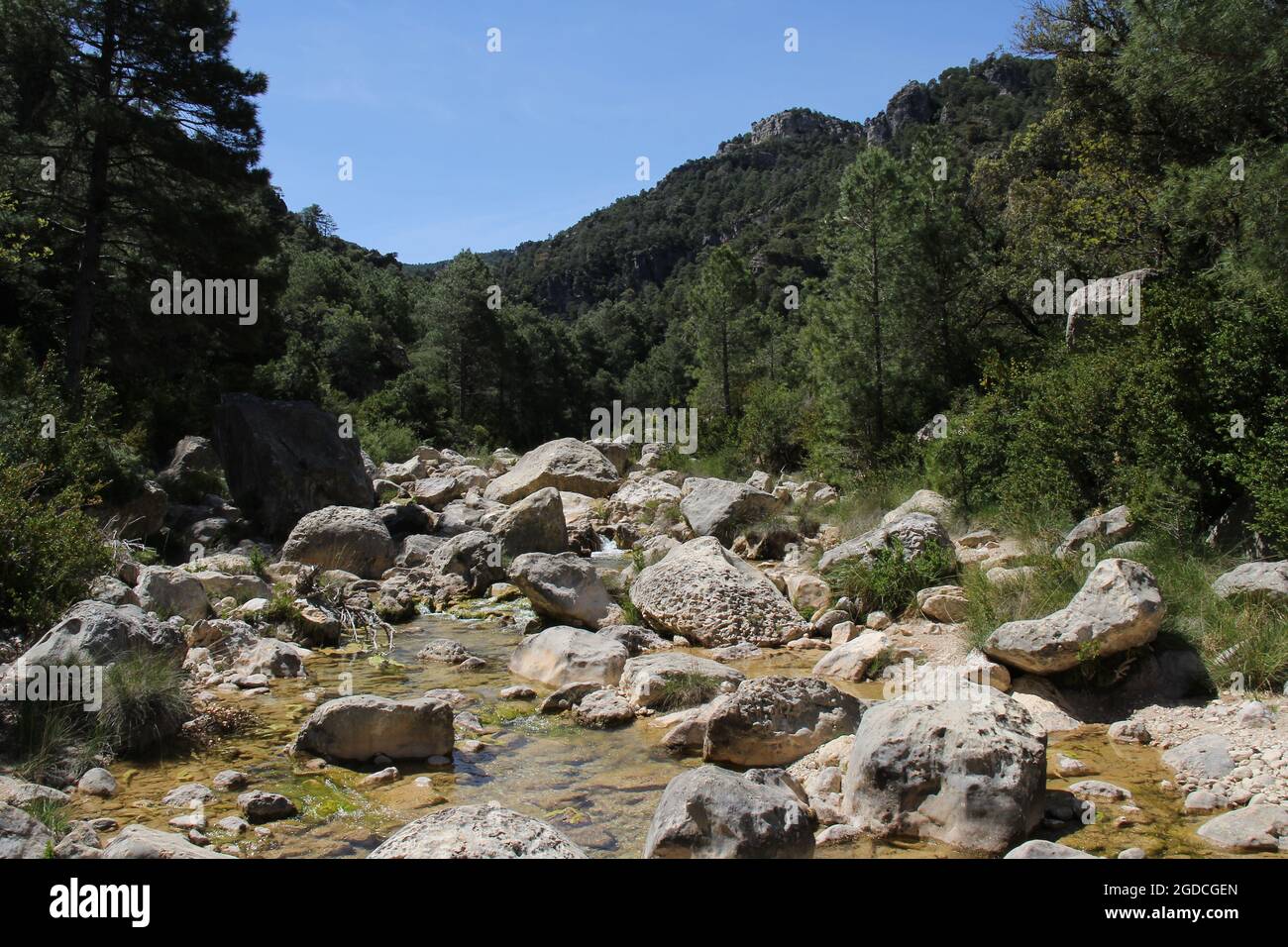 Landscape of a river flowing between the rocks with green hills on the ...