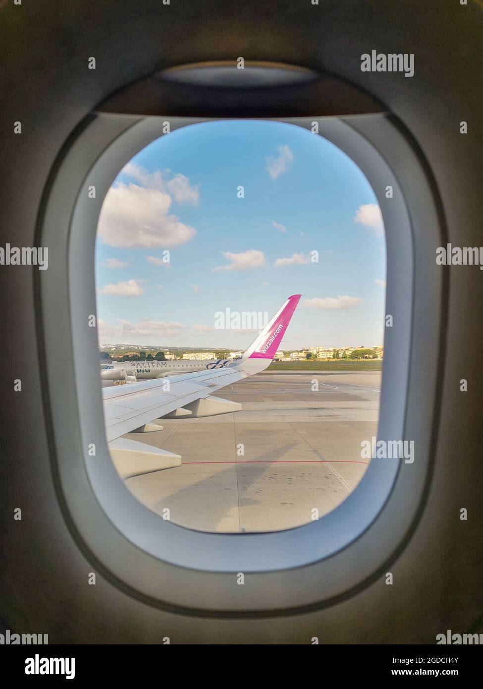 Naples, Italy - August 27 2020: Window view to big airport and square ...